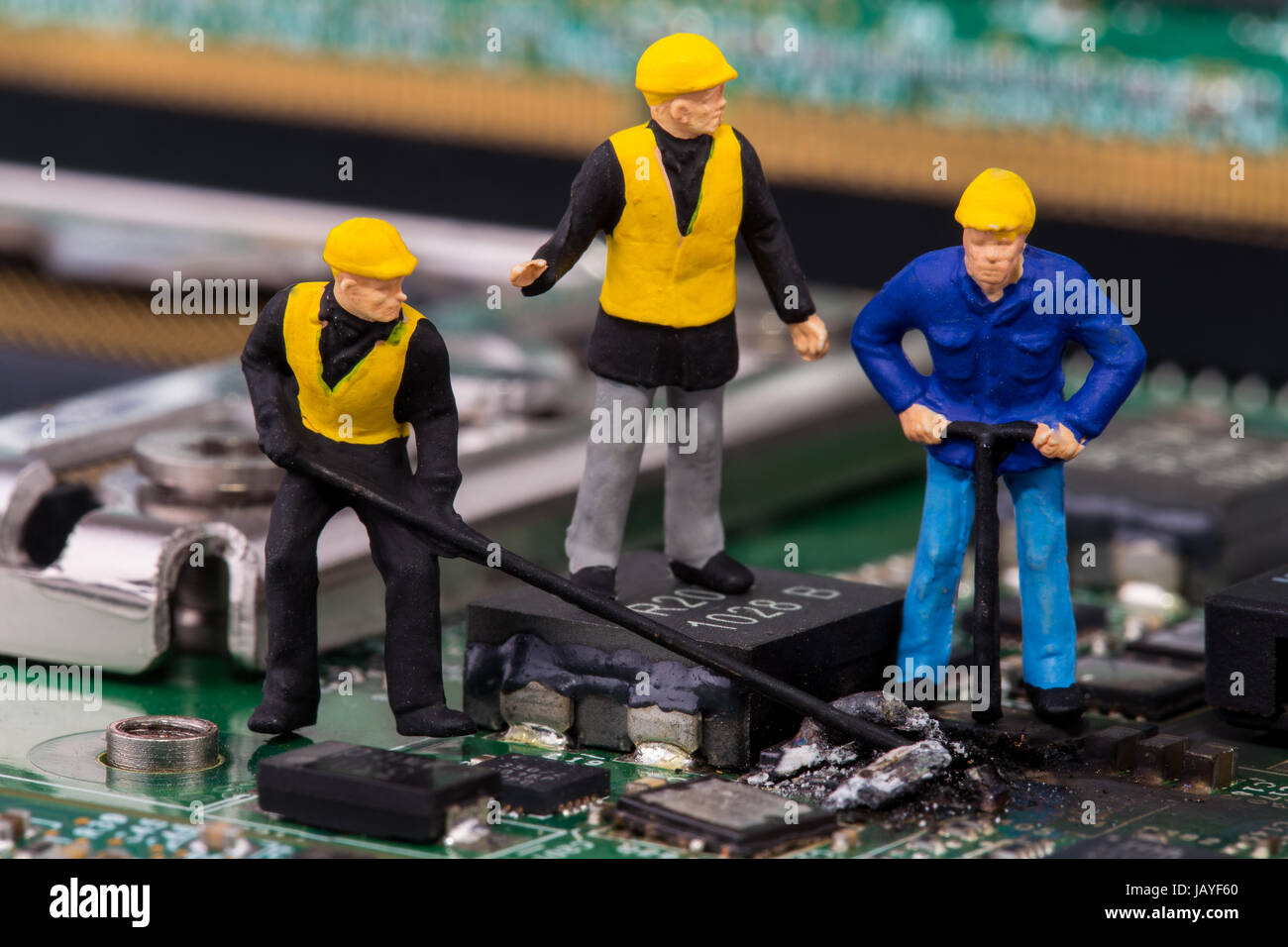 miniature workers on a computer mainboard - studio shot Stock Photo - Alamy