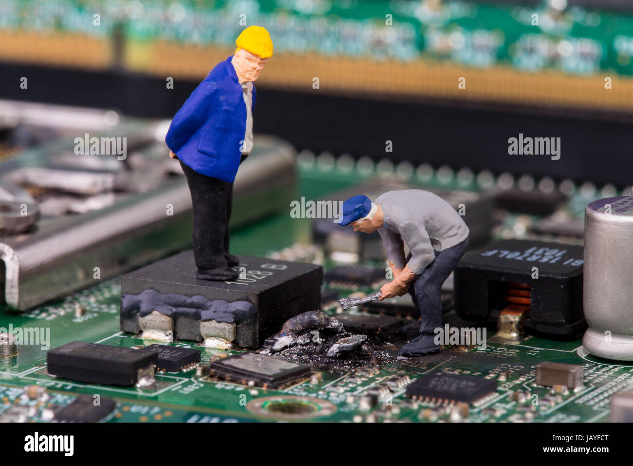 miniature workers on a computer mainboard - studio shot Stock Photo - Alamy