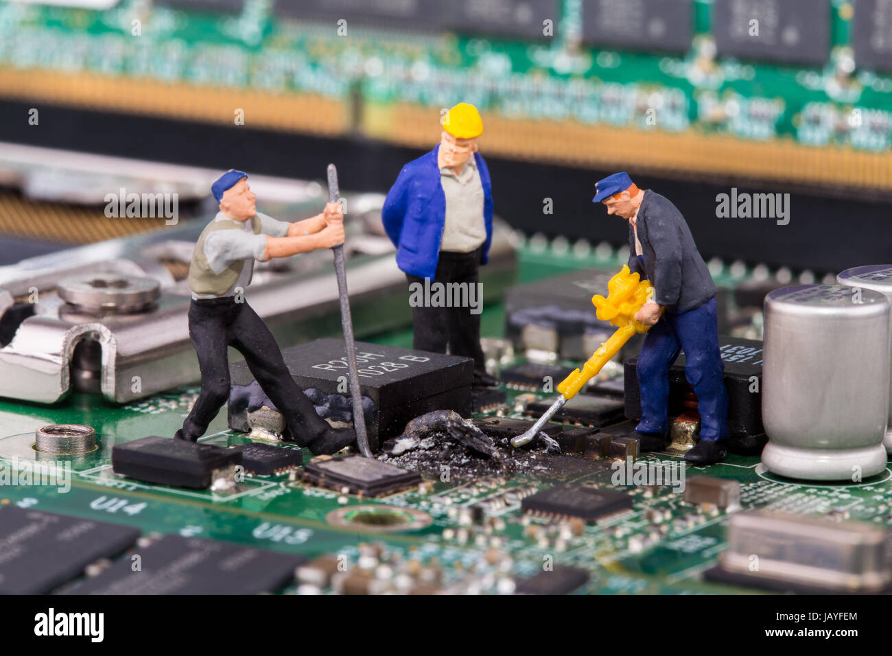 miniature workers on a computer mainboard - studio shot Stock Photo - Alamy