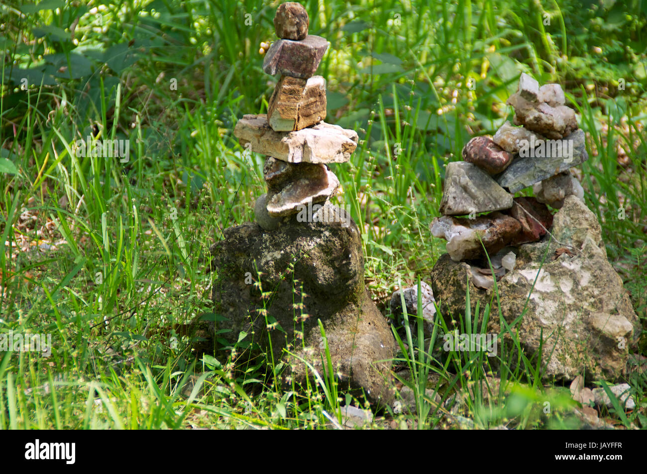 Two piles of rocks are stacked up making towers in the middle of the ...