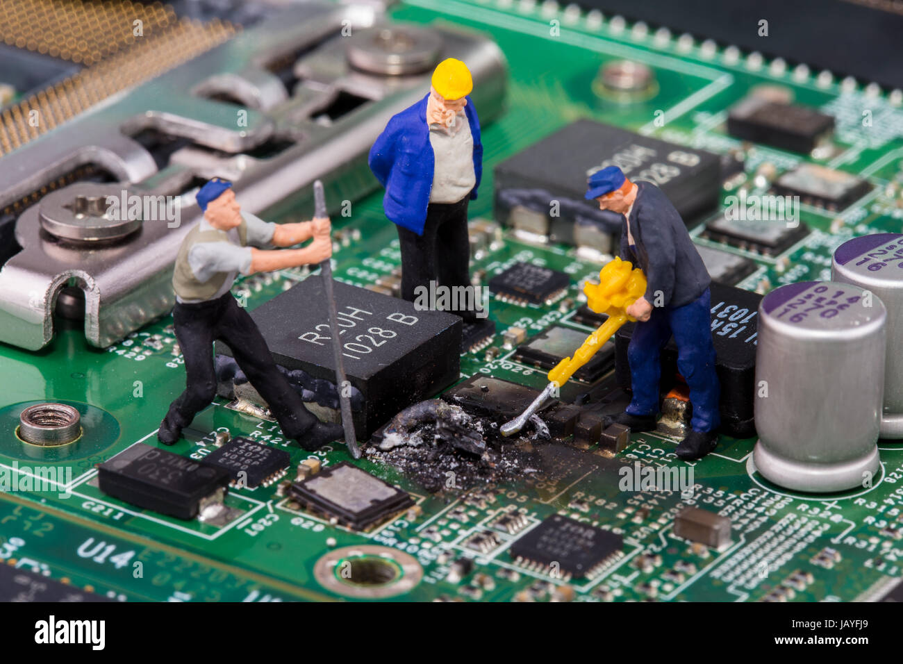 miniature workers on a computer mainboard - studio shot Stock Photo - Alamy