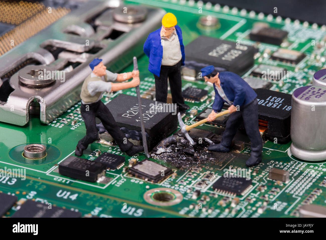 miniature workers on a computer mainboard - studio shot Stock Photo - Alamy