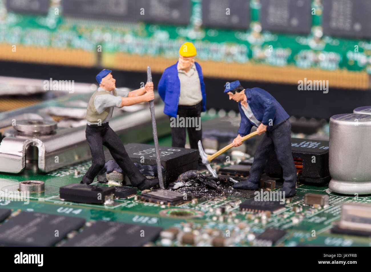 miniature workers on a computer mainboard - studio shot Stock Photo - Alamy