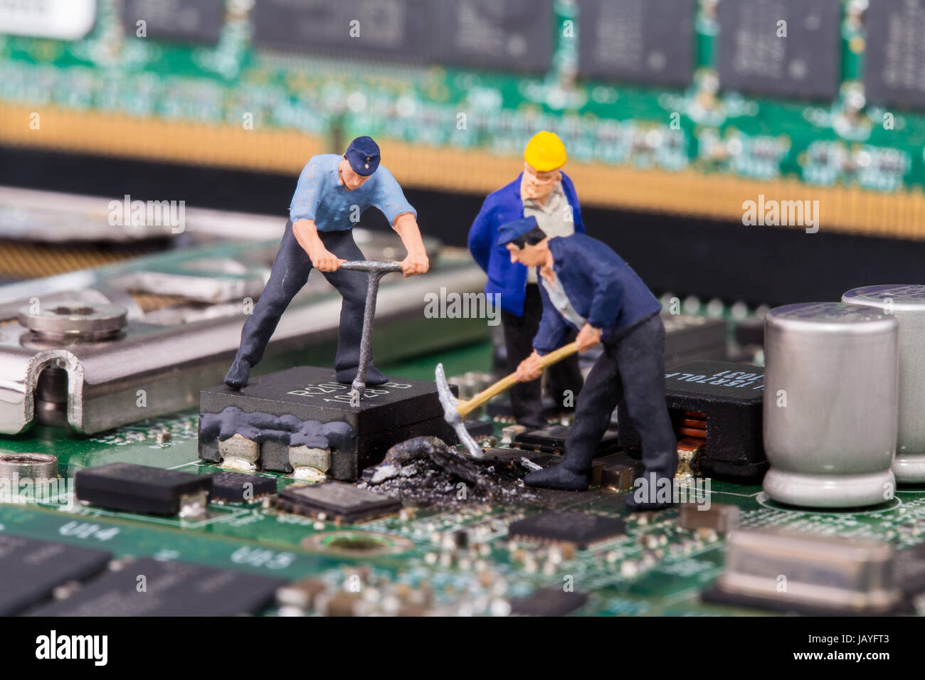 miniature workers on a computer mainboard - studio shot Stock Photo - Alamy