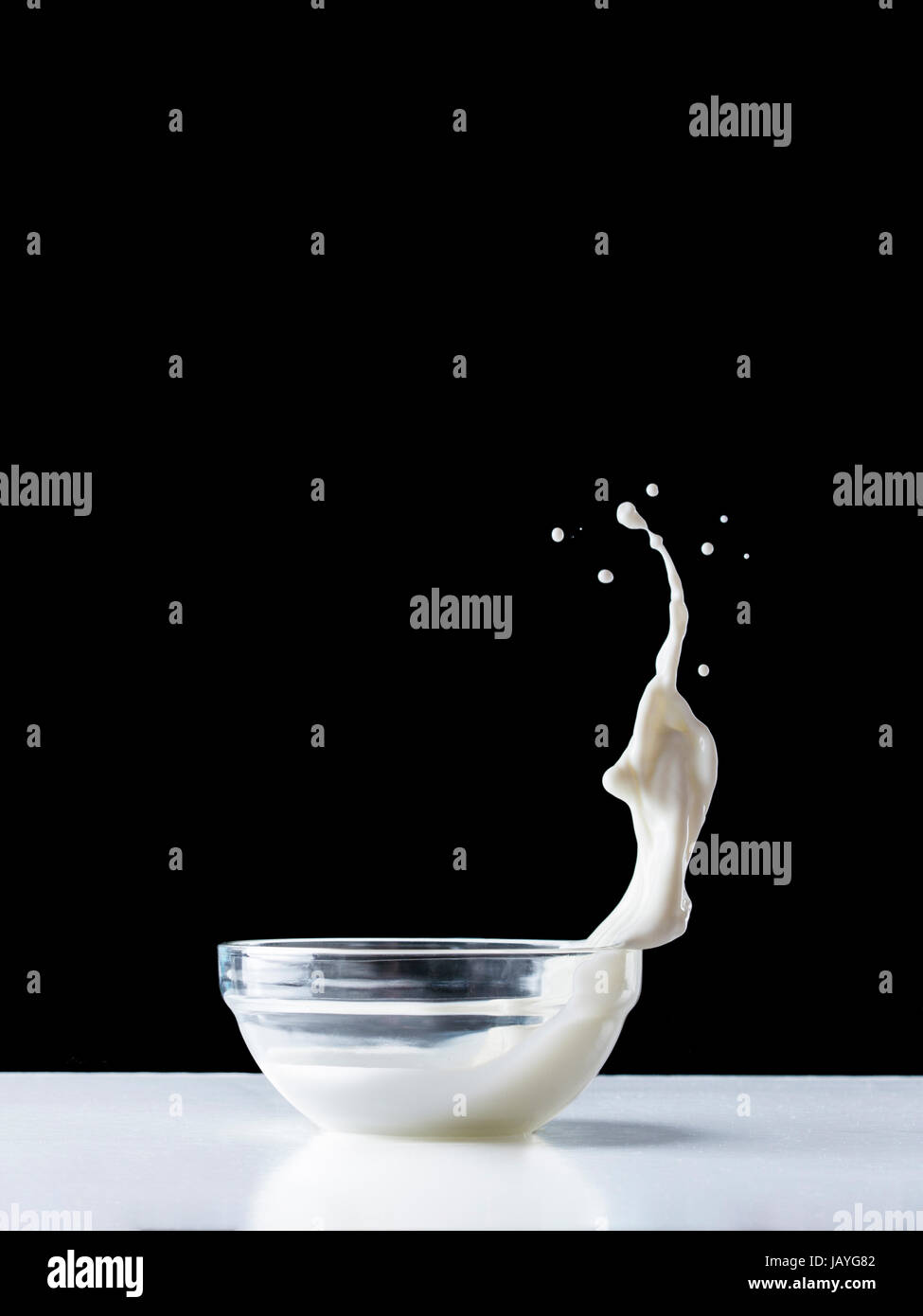 Milk splash in glass plate Stock Photo - Alamy