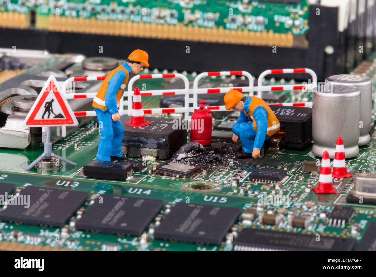 miniature workers on a computer mainboard - studio shot Stock Photo - Alamy