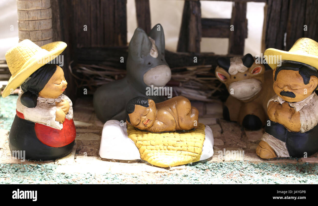 Mexican Nativity scene with the holy family with the statues of the ox ...