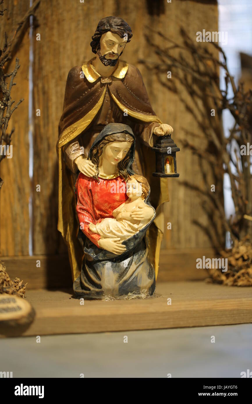 nativity scene with the Holy Family and Saint joseph who holds a ...