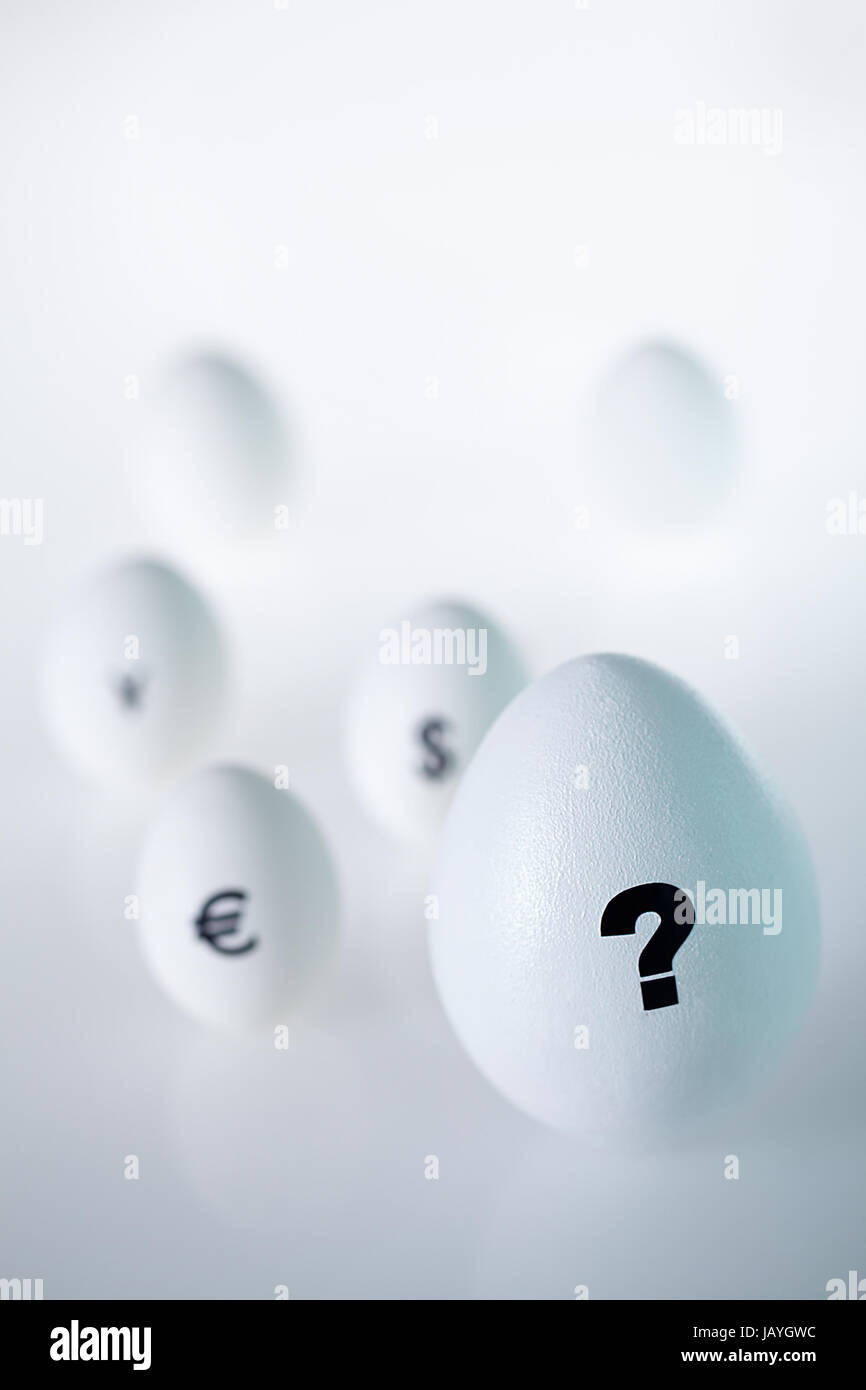 Close-up of big white egg with question mark on it among other eggs ...