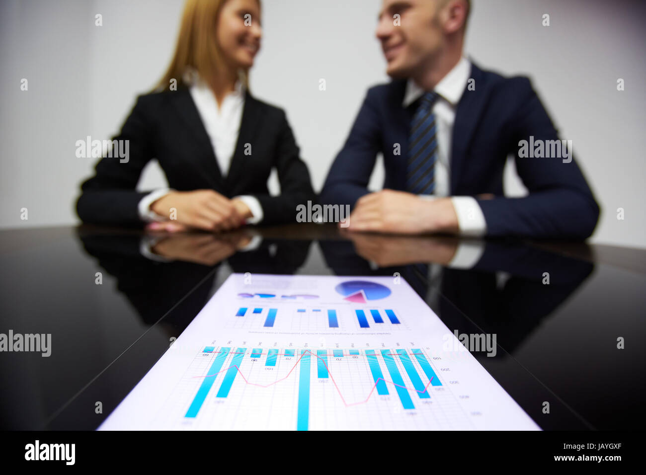 Image of business paper at workplace and business partners on ...