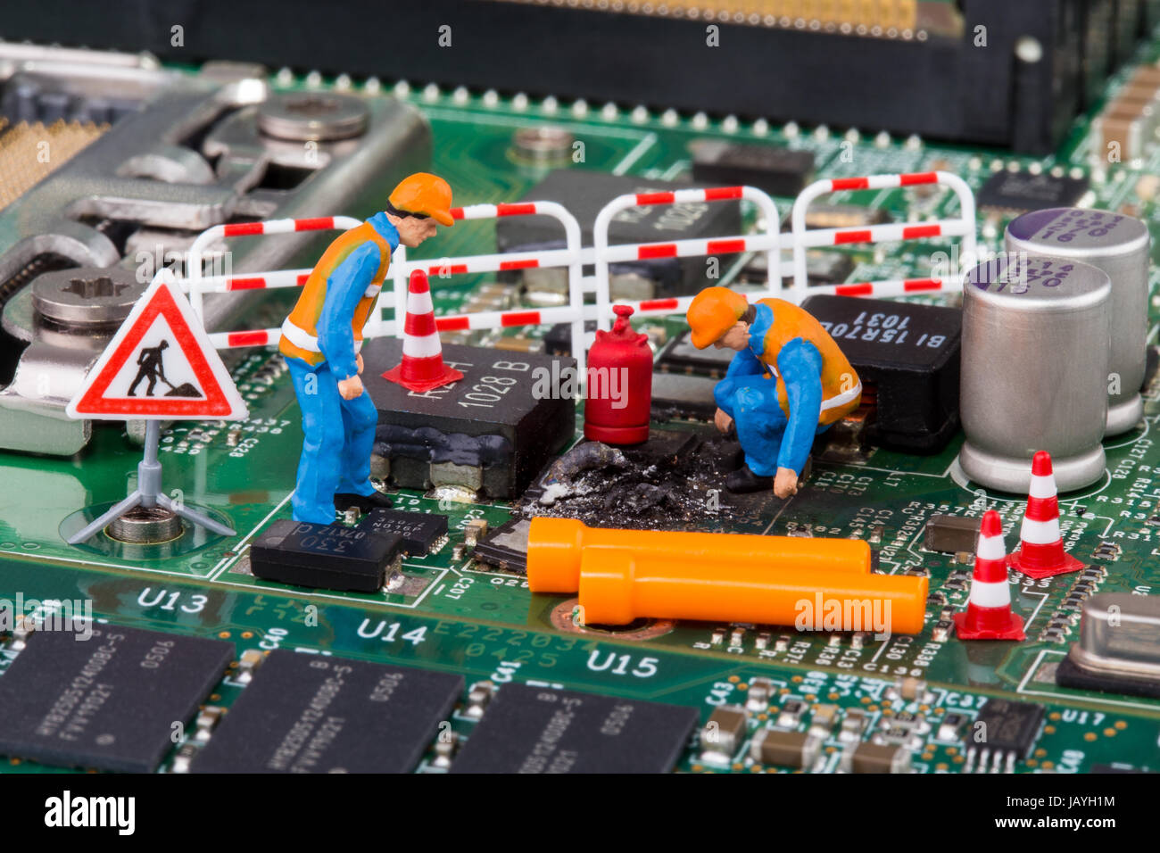 miniature workers on a computer mainboard - studio shot Stock Photo - Alamy