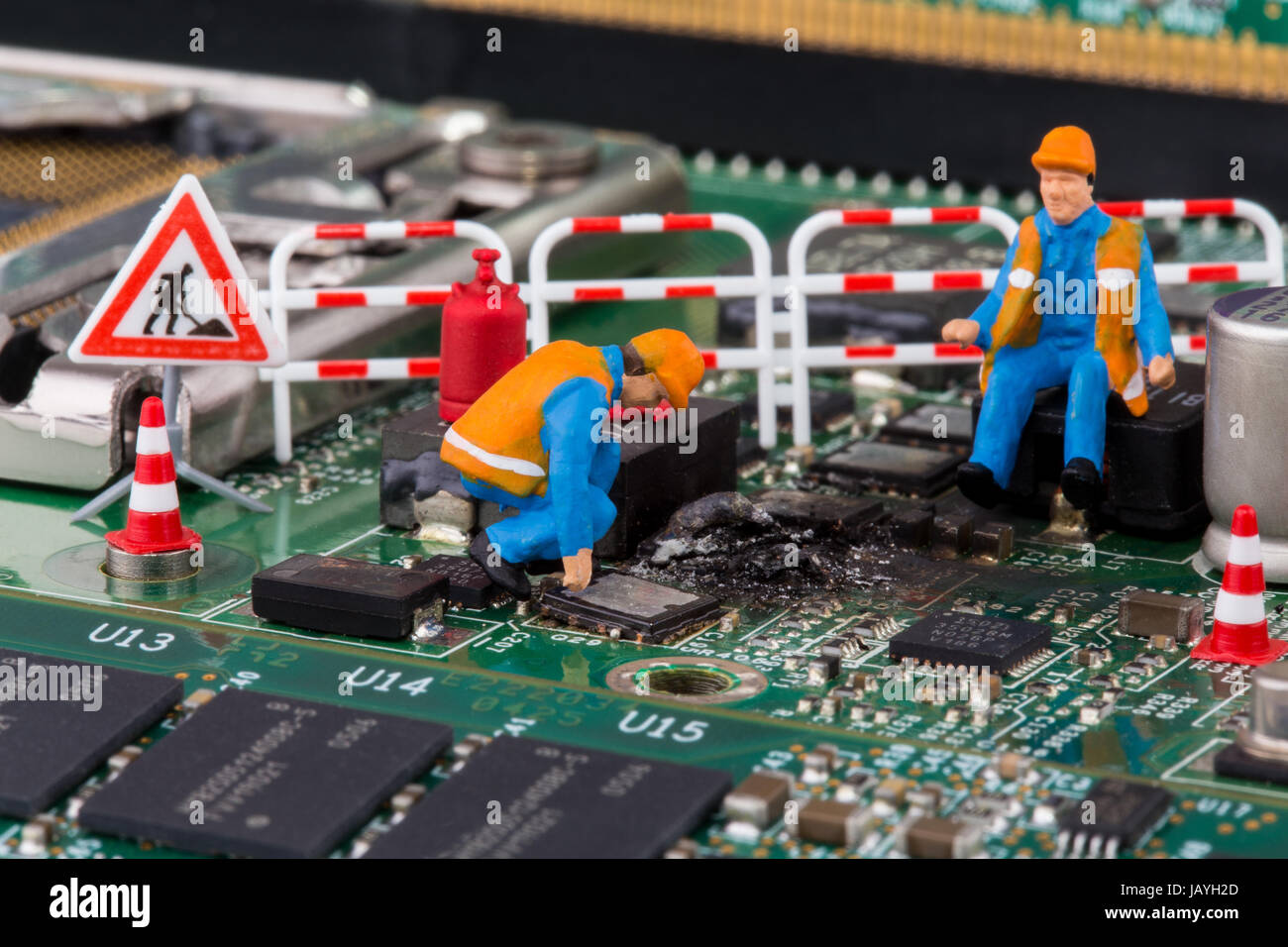 miniature workers on a computer mainboard - studio shot Stock Photo - Alamy