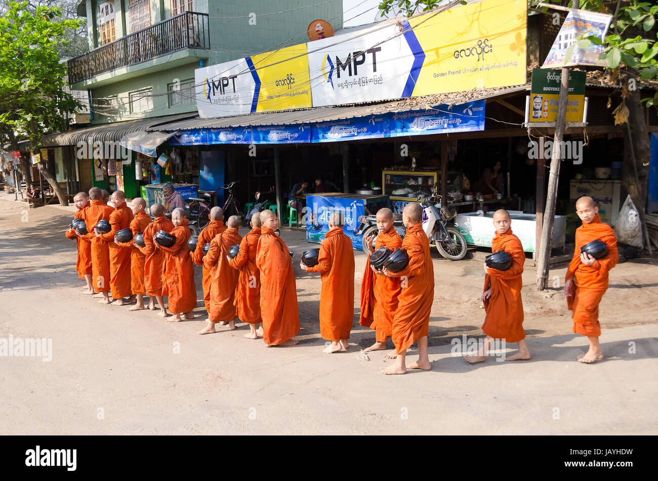 Monks collecting donations of food, Pakokku, Myanmar Stock Photo - Alamy