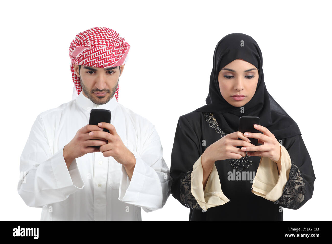 Front view of a saudi couple addicted to the smart phone isolated on a ...