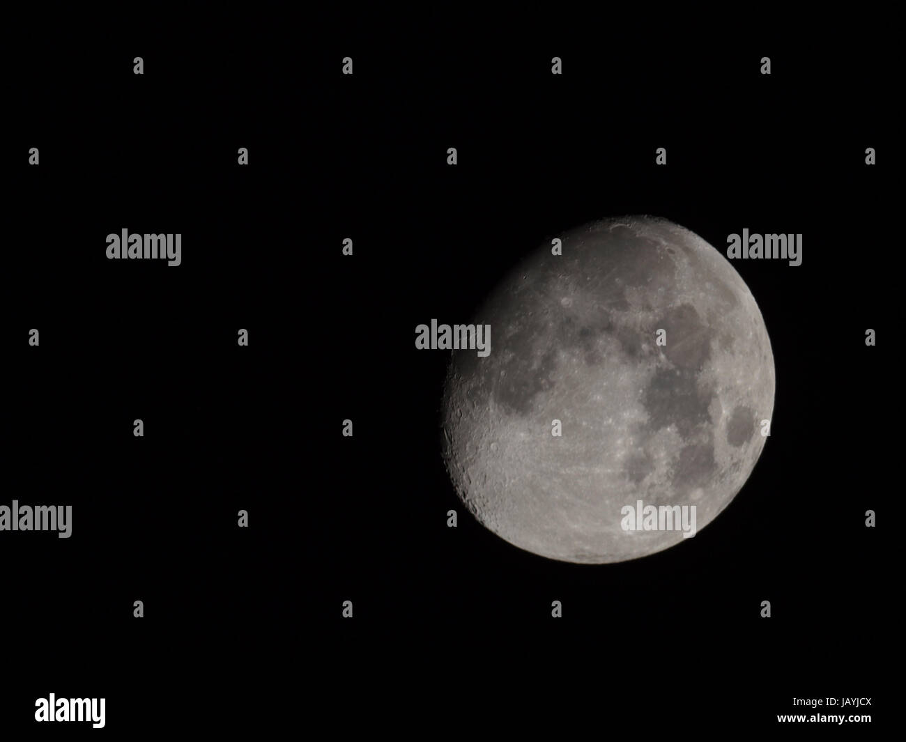 Near full moon seen with a telescope Stock Photo - Alamy