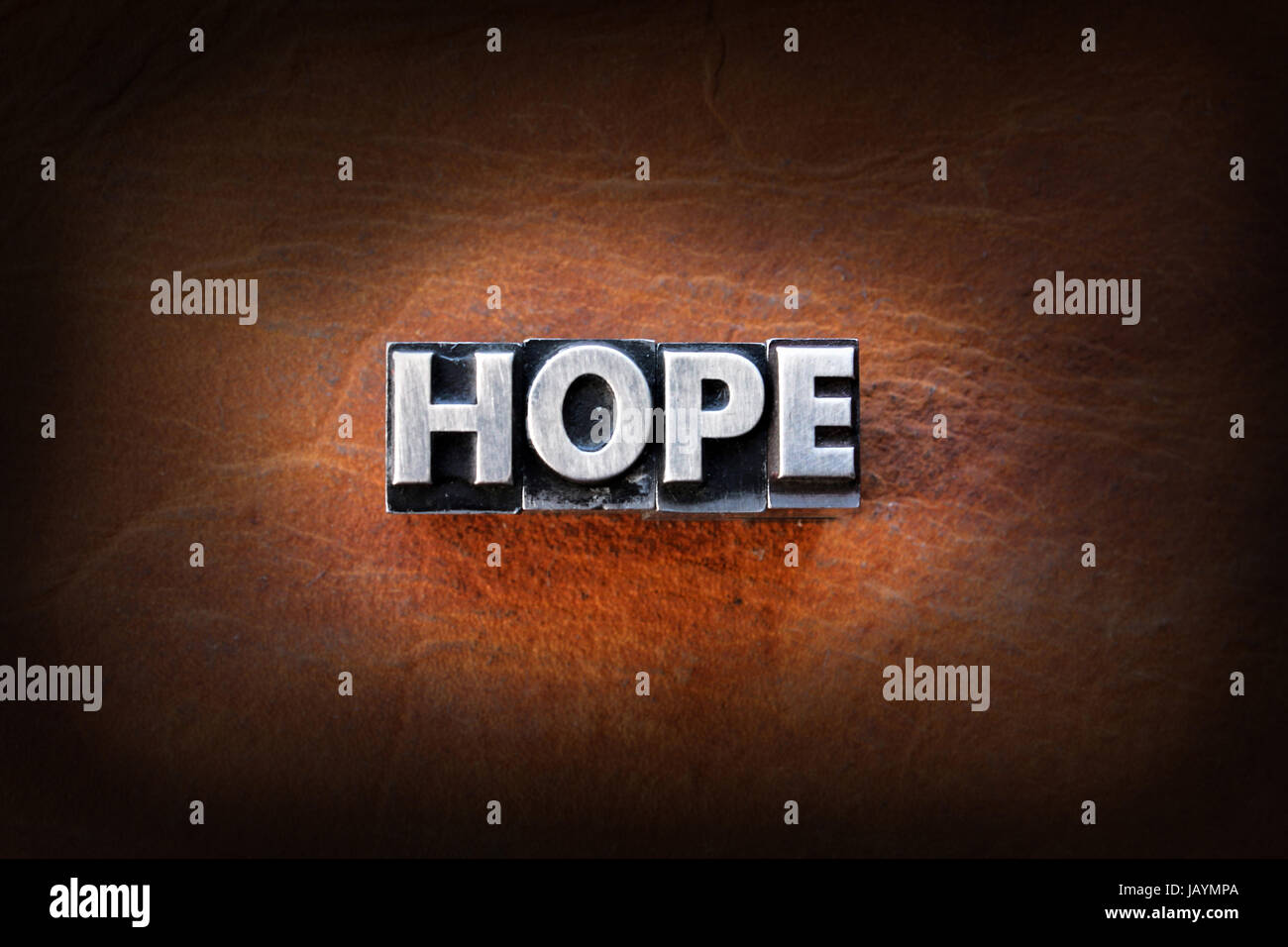 The word hope made from vintage lead letterpress type on a leather ...
