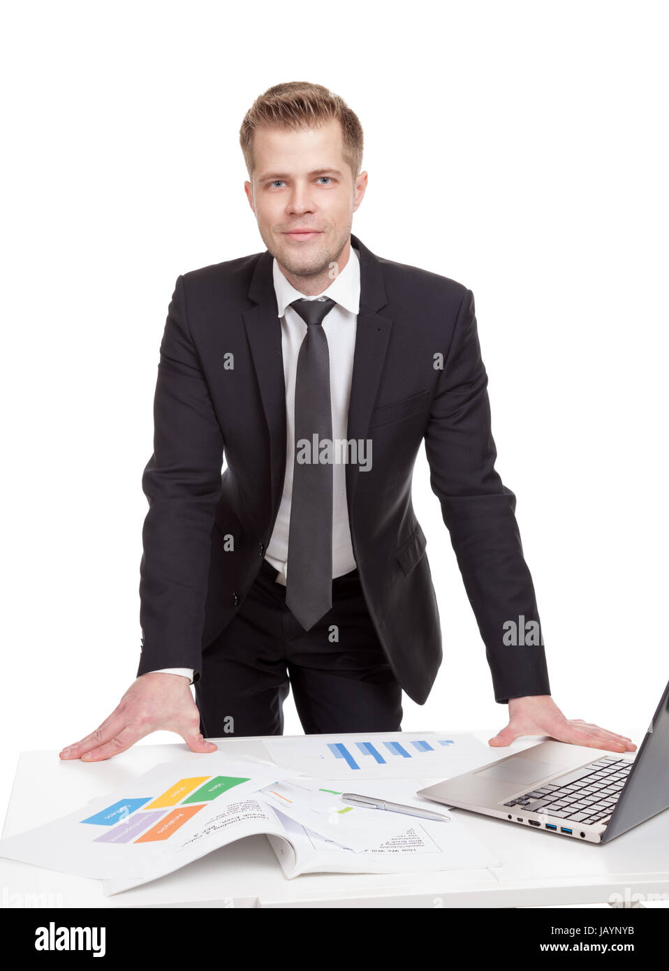 Handsome businessman standing behind the office desk Stock Photo - Alamy