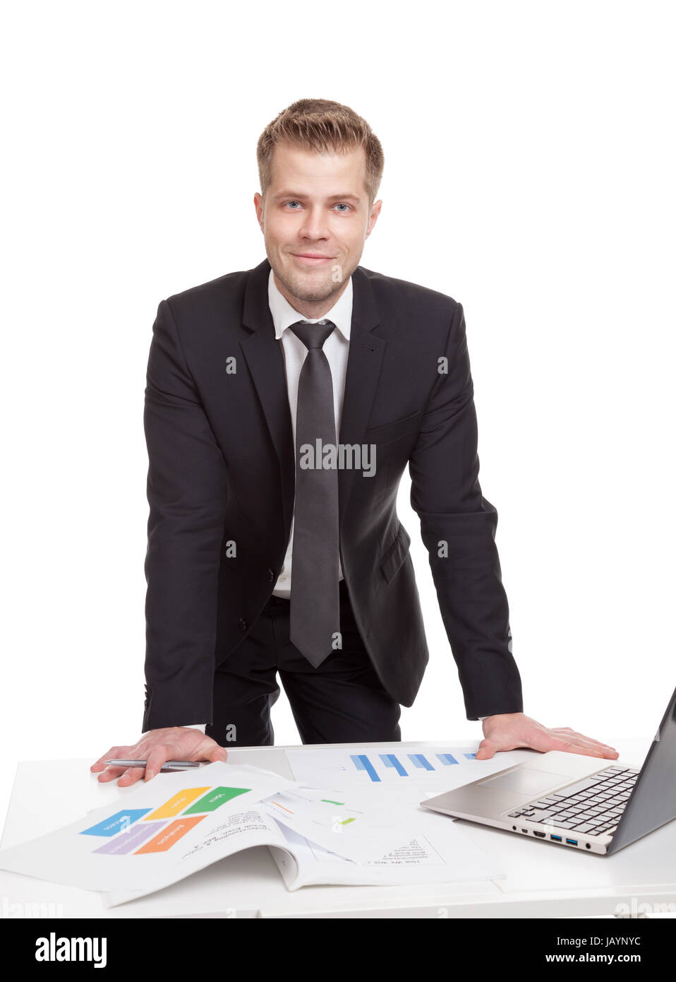 Handsome businessman standing behind the office desk Stock Photo - Alamy
