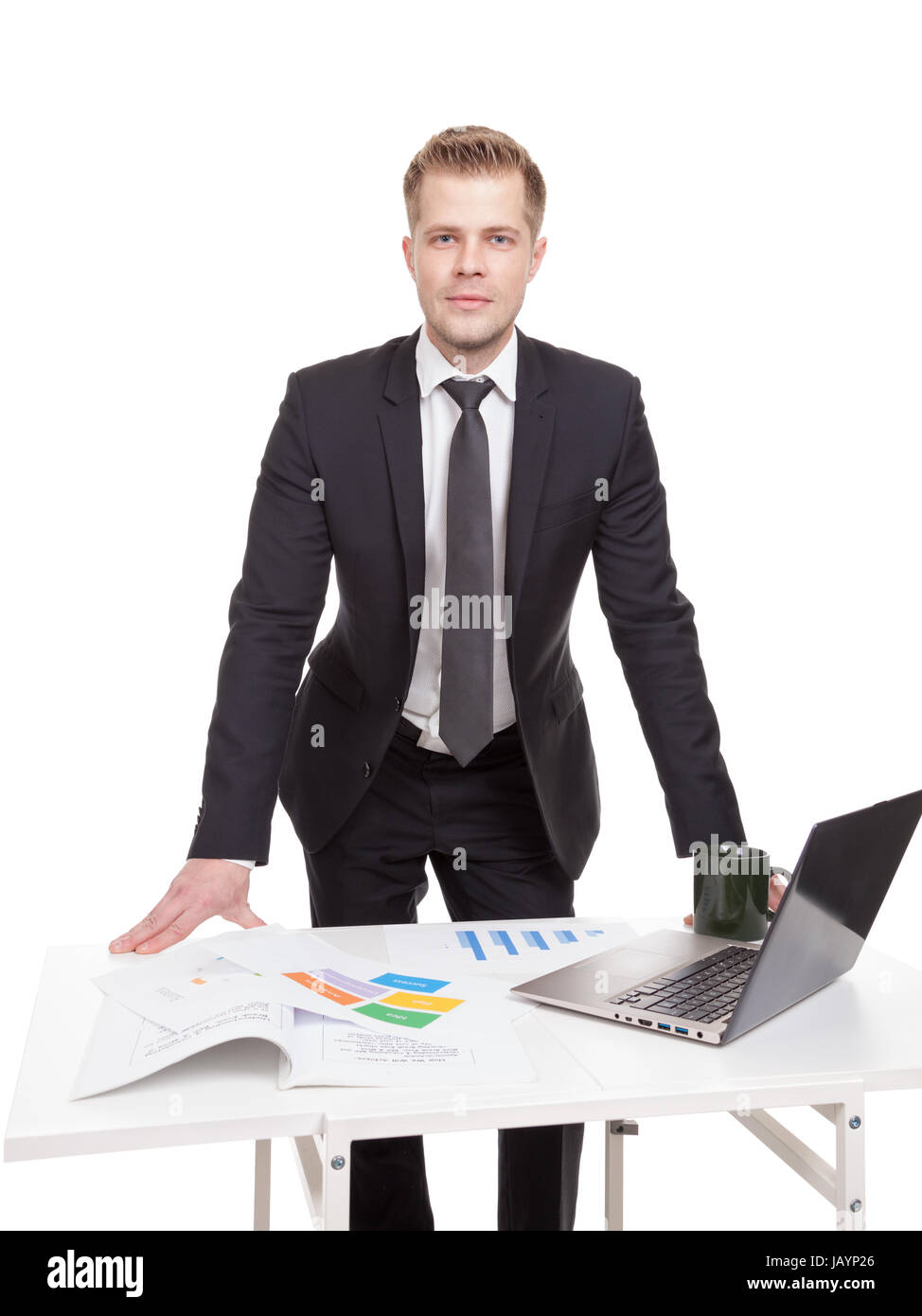 Handsome businessman standing behind the office desk Stock Photo - Alamy