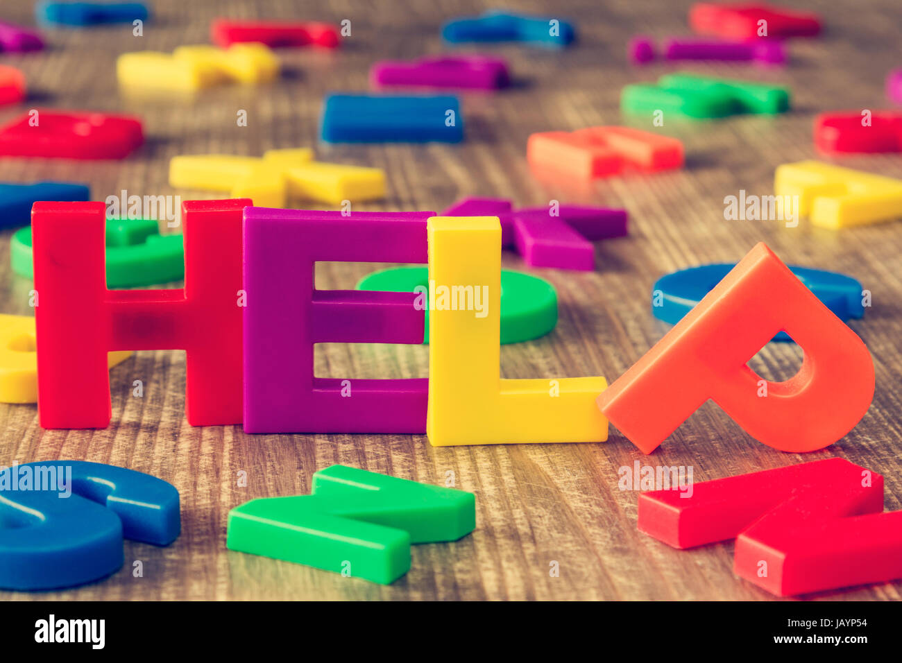 Plastic letters spelling word HELP on wooden background Stock Photo - Alamy