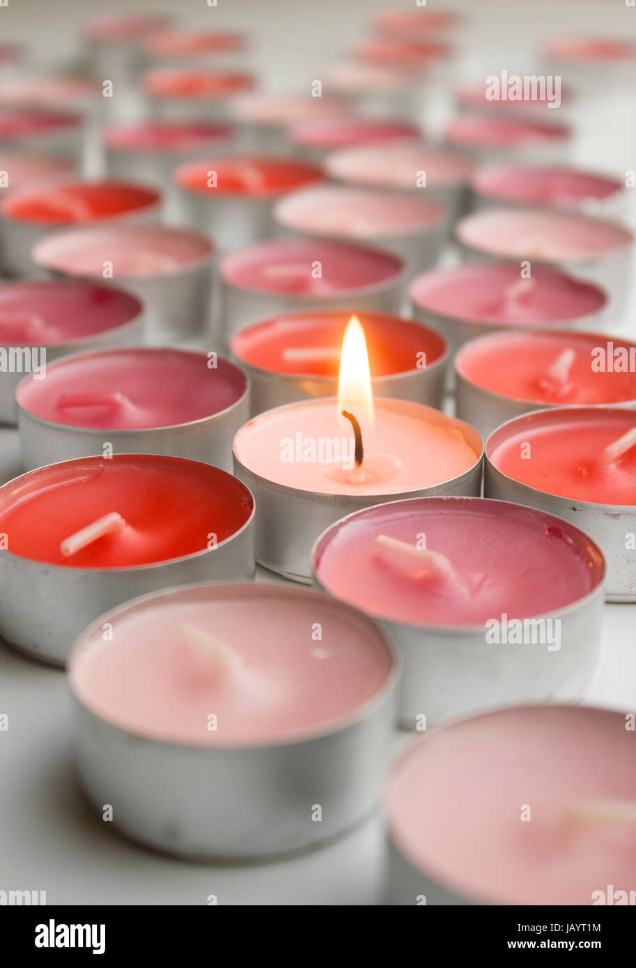 Different colors of candles in a indoor composition Stock Photo - Alamy