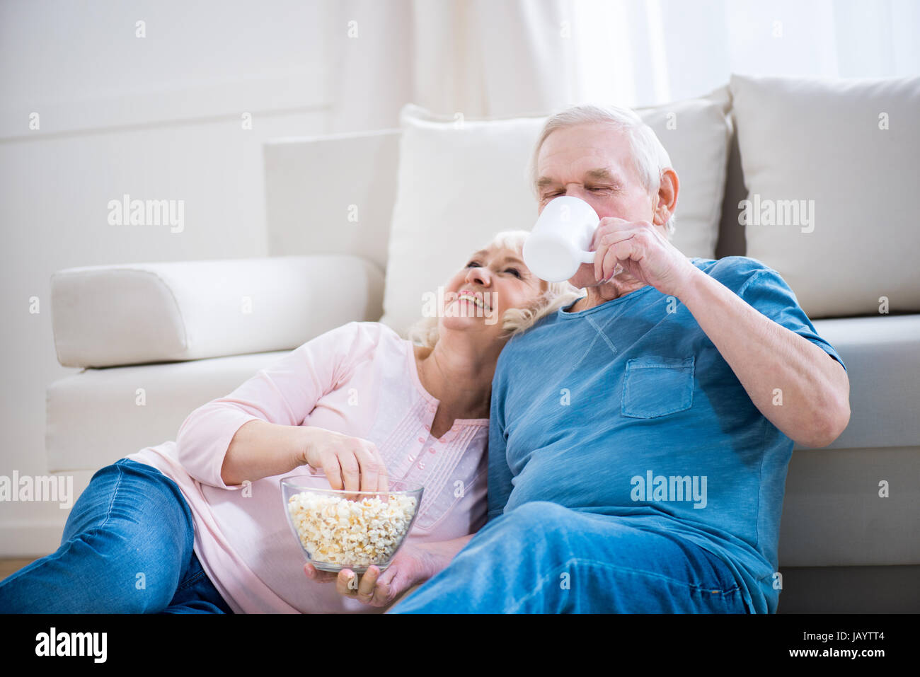 Laughing caucasian man eating popcorn hi-res stock photography and ...