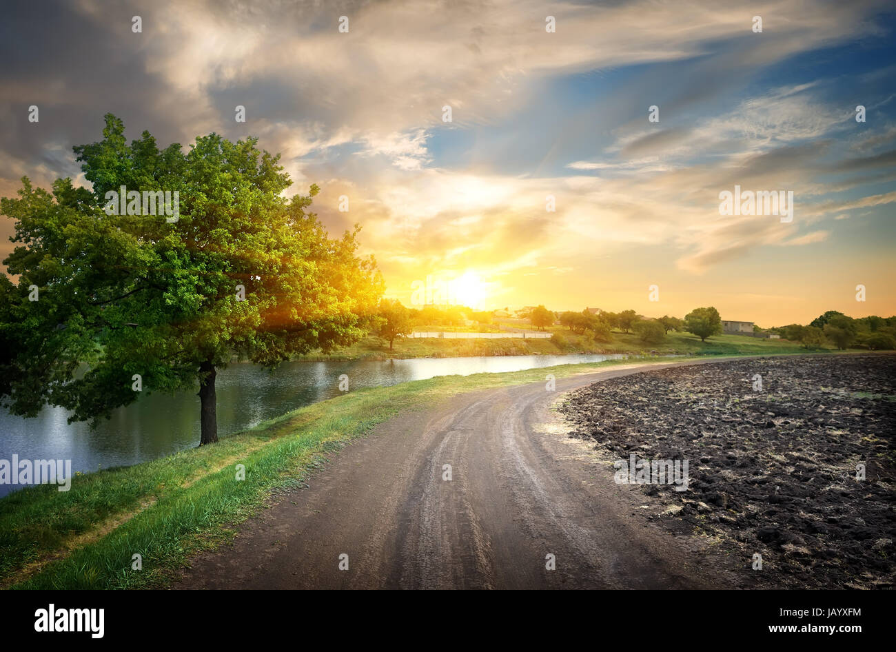 Sunset over the country road the river Stock Photo - Alamy