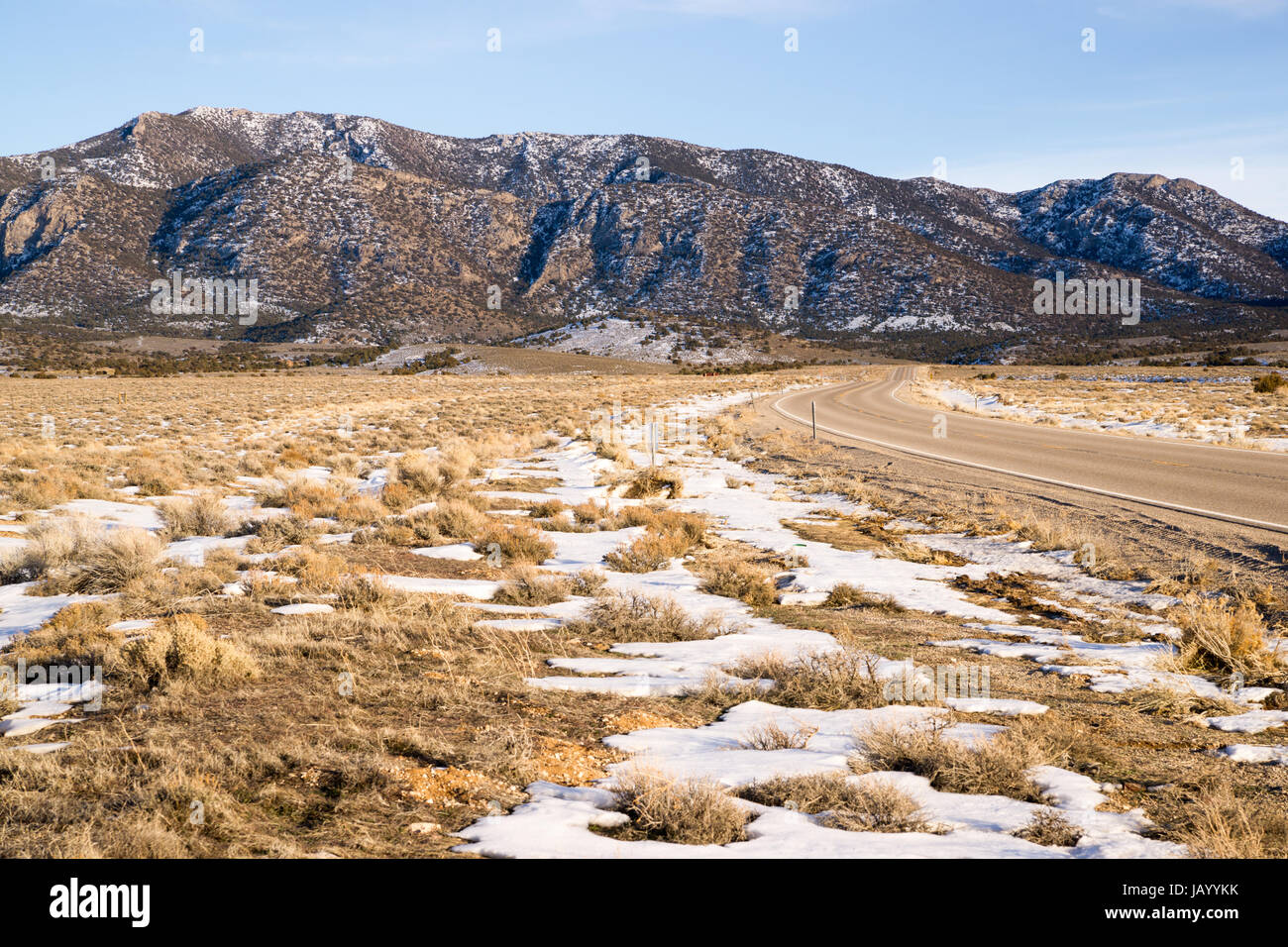 The road is clear and dry but winter waits to ice it up again Stock ...