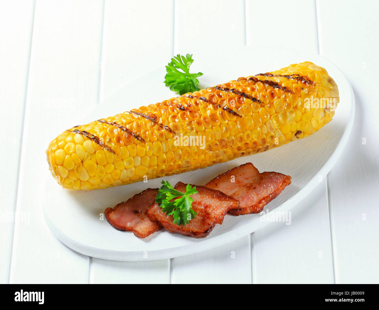 Grilled corn and fried pieces of salt pork Stock Photo - Alamy