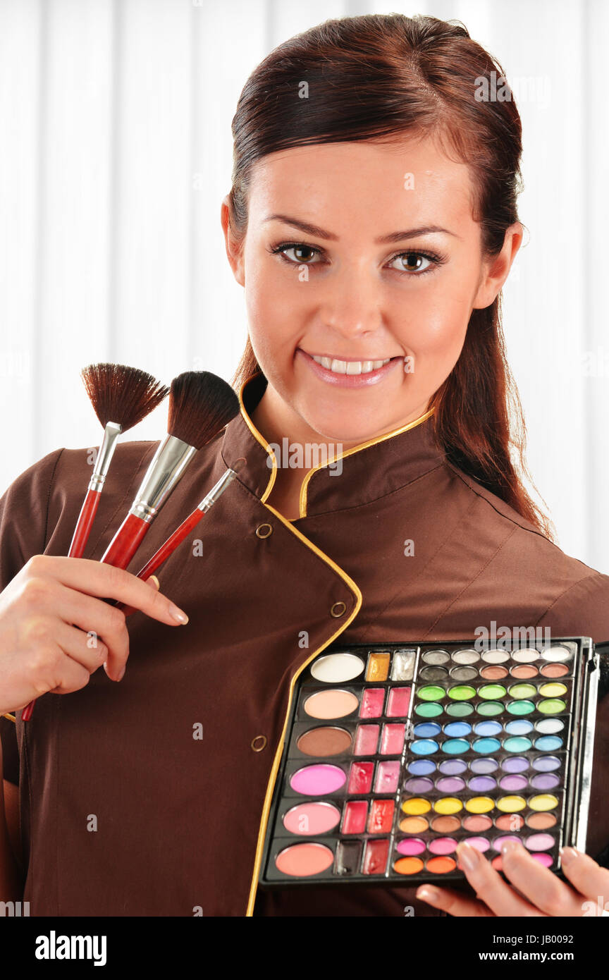 Professional beautician holding brushes Stock Photo - Alamy