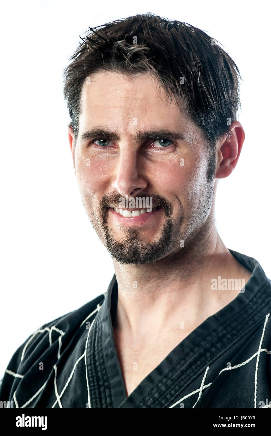Portrait of a laughing man martial arts master with beard and black ...