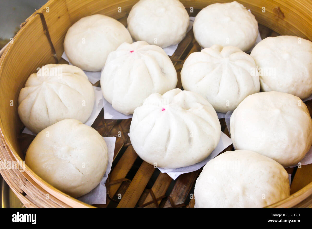Chinese dumplings being steamed on the traditional bamboo pan Stock ...