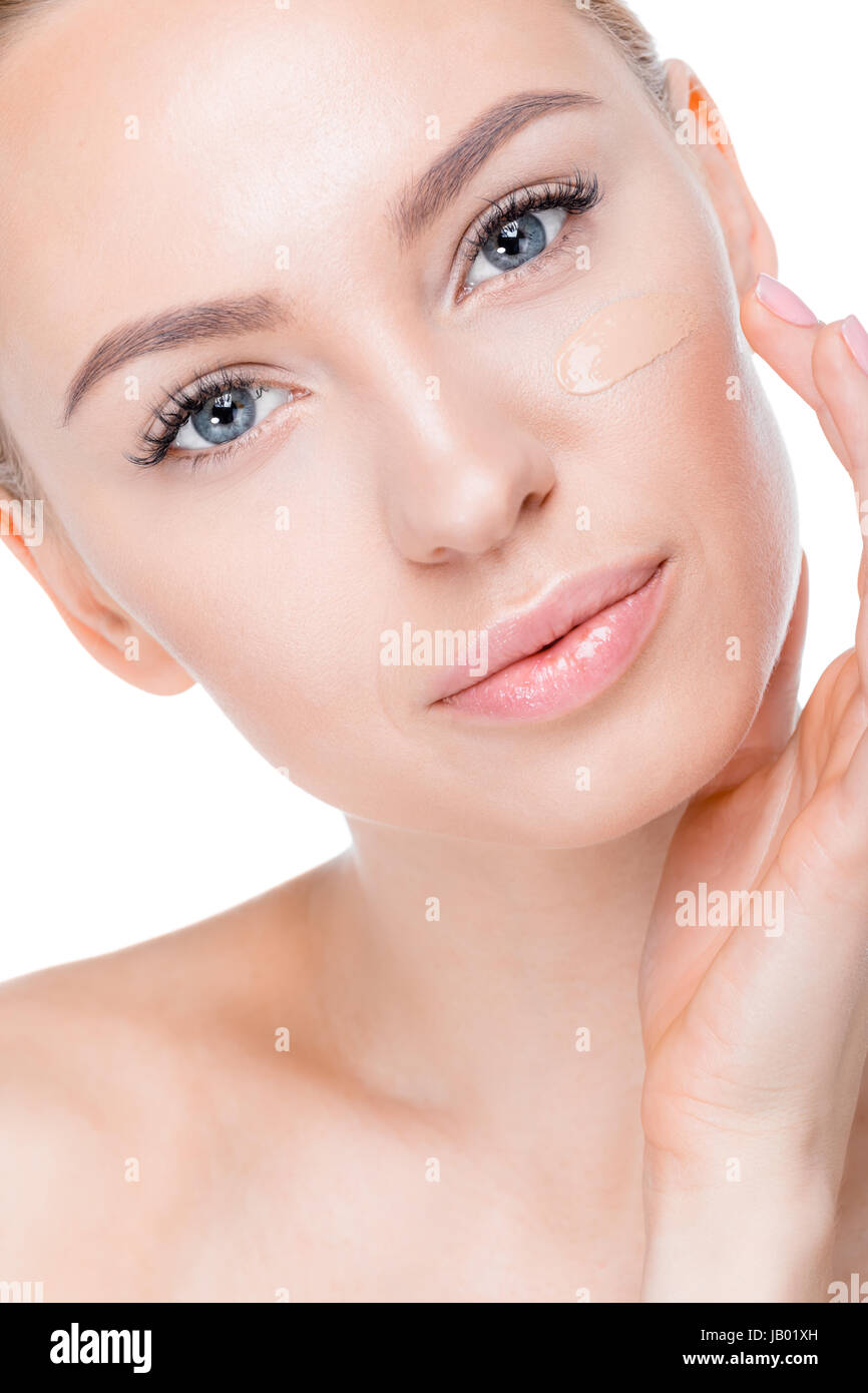 portrait of woman with foundation cream on face looking to camera Stock ...