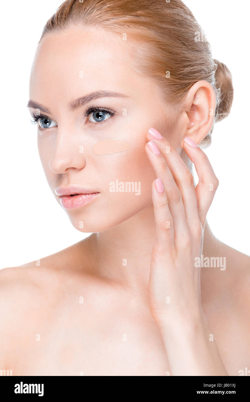 portrait of woman with foundation cream on face looking away Stock ...