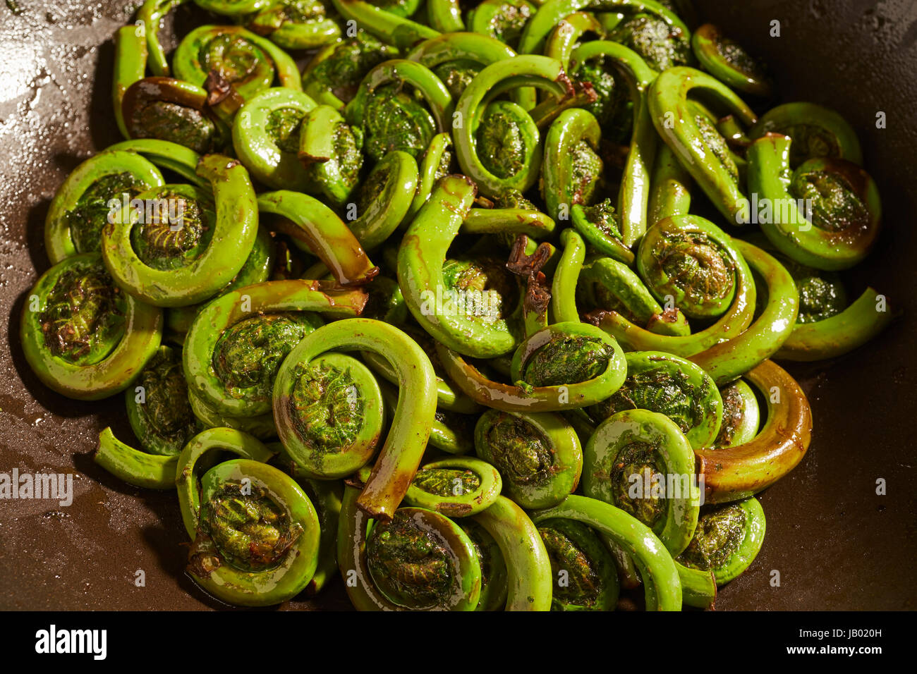 pan fried fiddleheads Stock Photo - Alamy