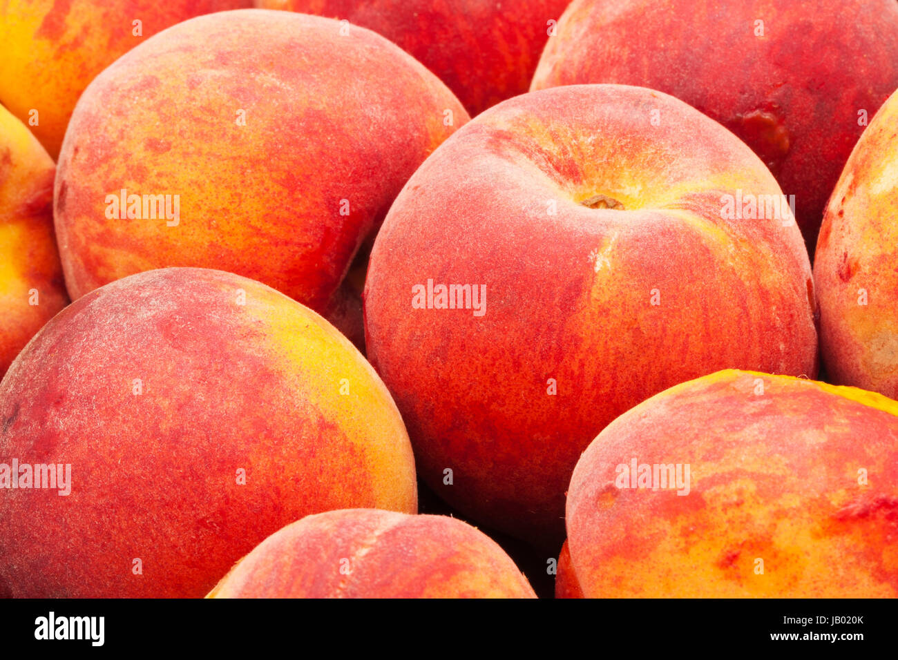 Fresh sweet red peaches making nice background Stock Photo - Alamy