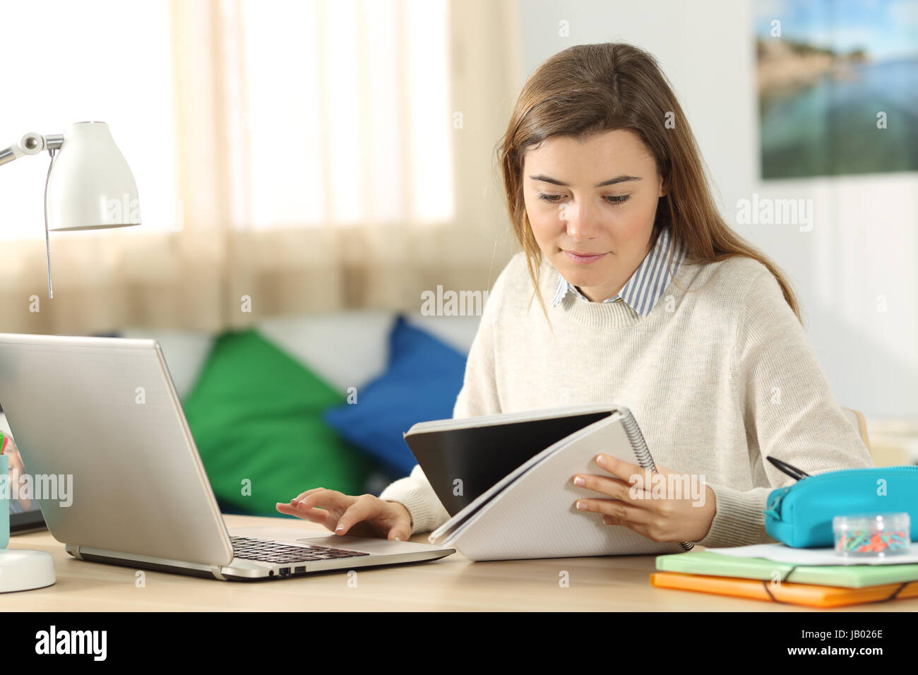 Single concentrated student studying reading notes sitting in a desk in ...