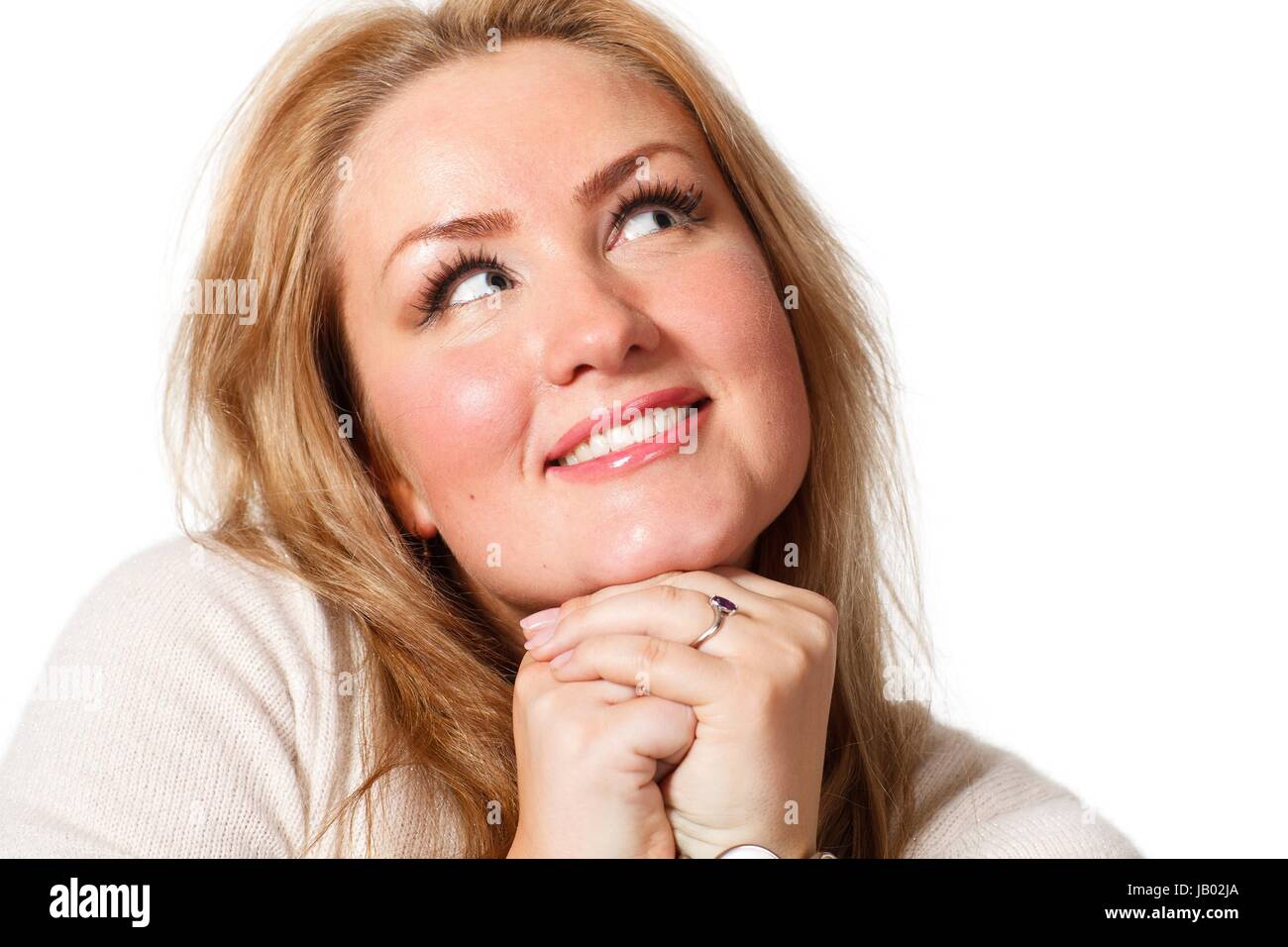 Portrait of young woman looking upwards on a white background Stock ...
