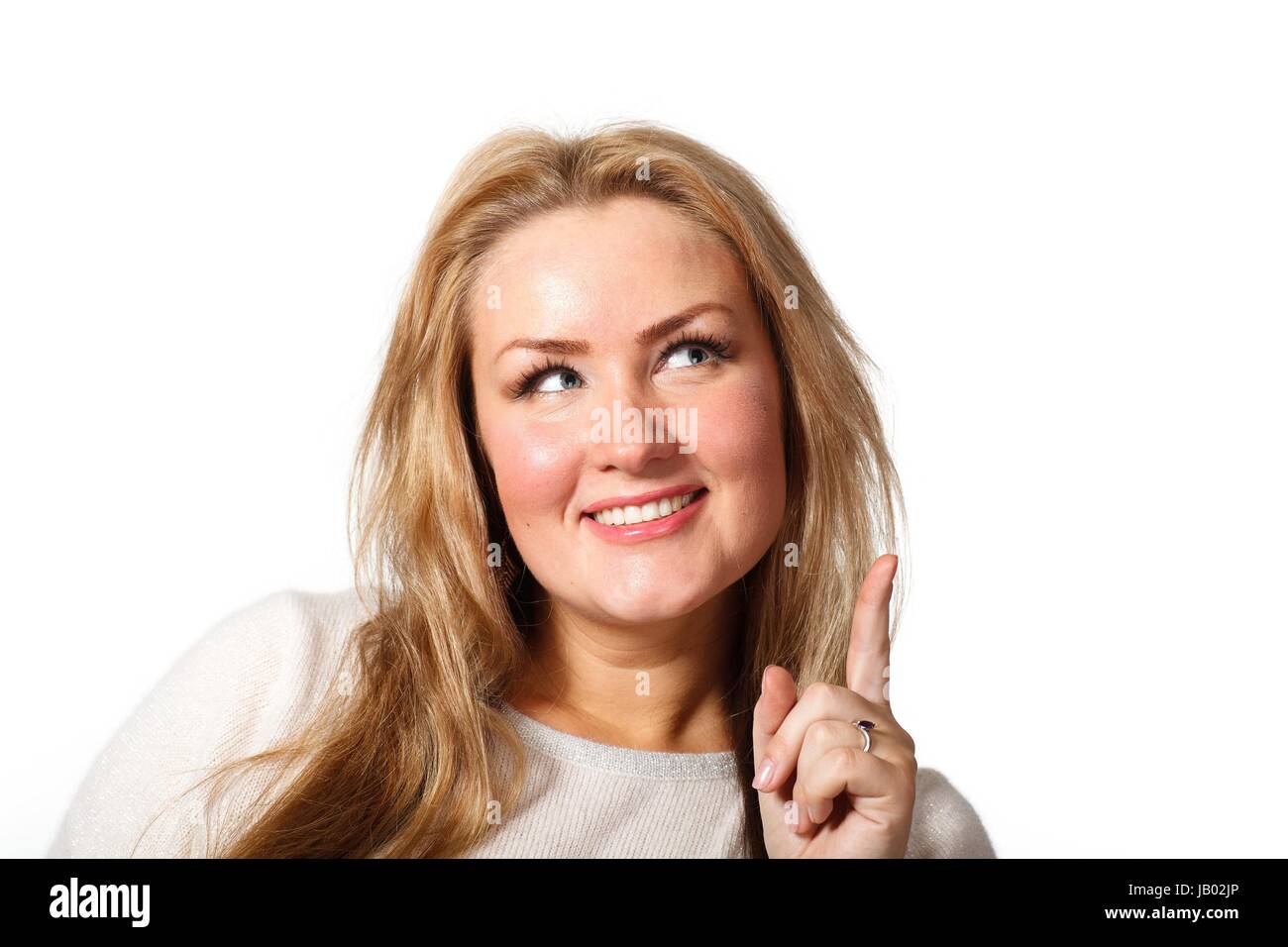 Portrait of young woman looking upwards on a white background Stock ...