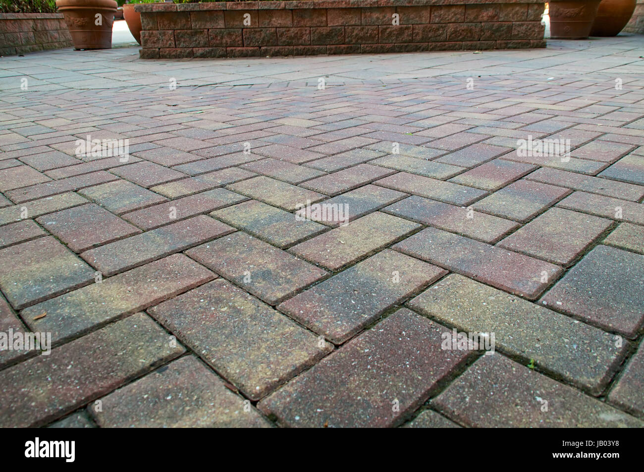 Red and Yellow pavers or bricks laid in a criss cross pattern fills the ...
