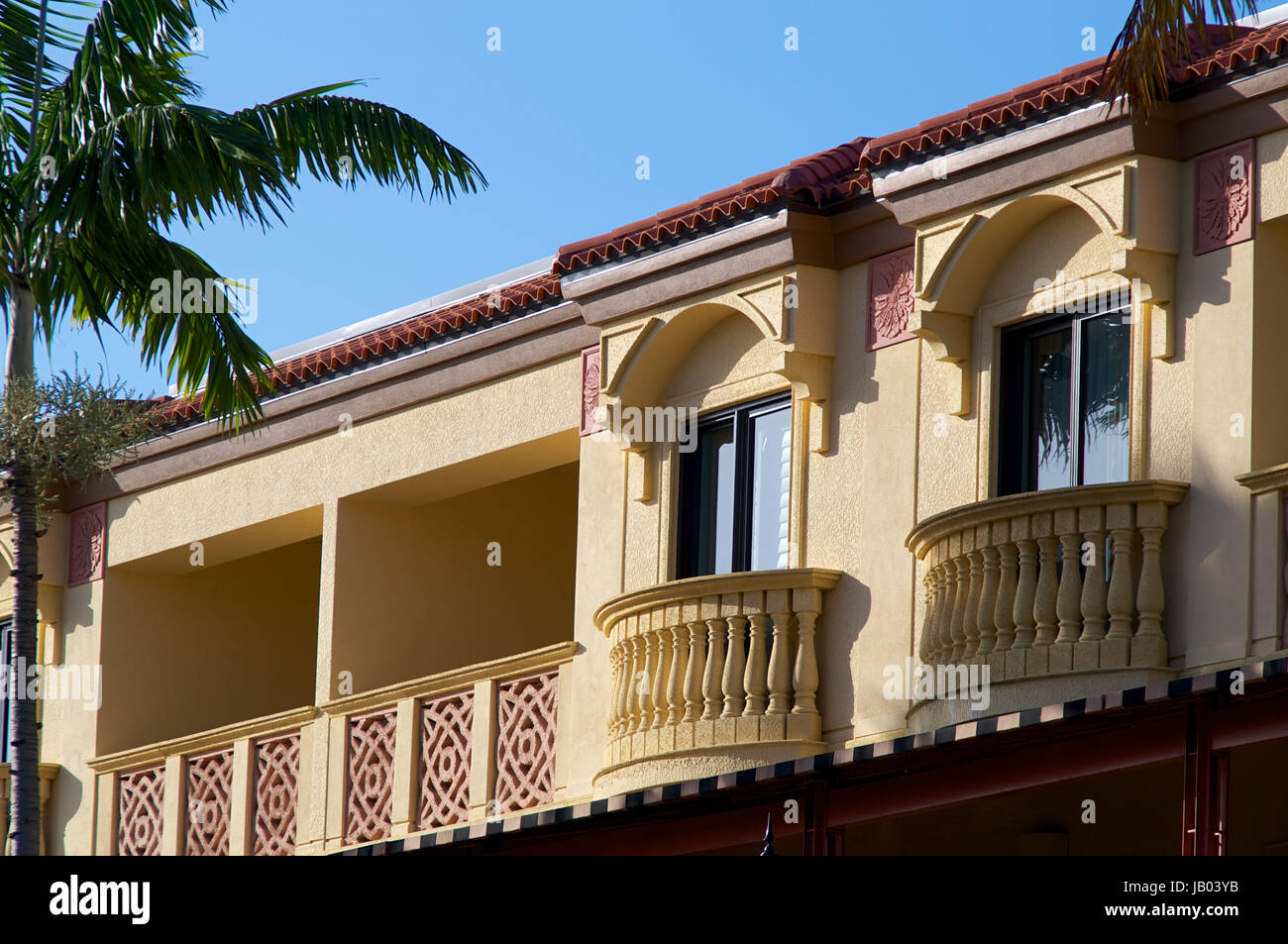 Generic red and yellow two story building in florida with balconies and ...