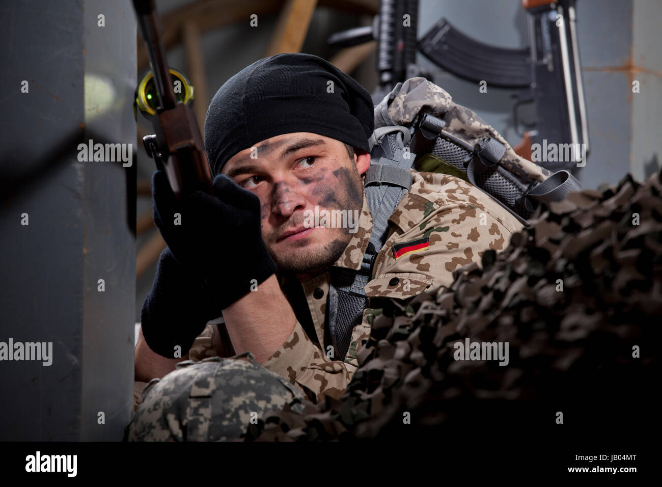 Male sniper in waiting position, hiding with sniper rifle Stock Photo ...