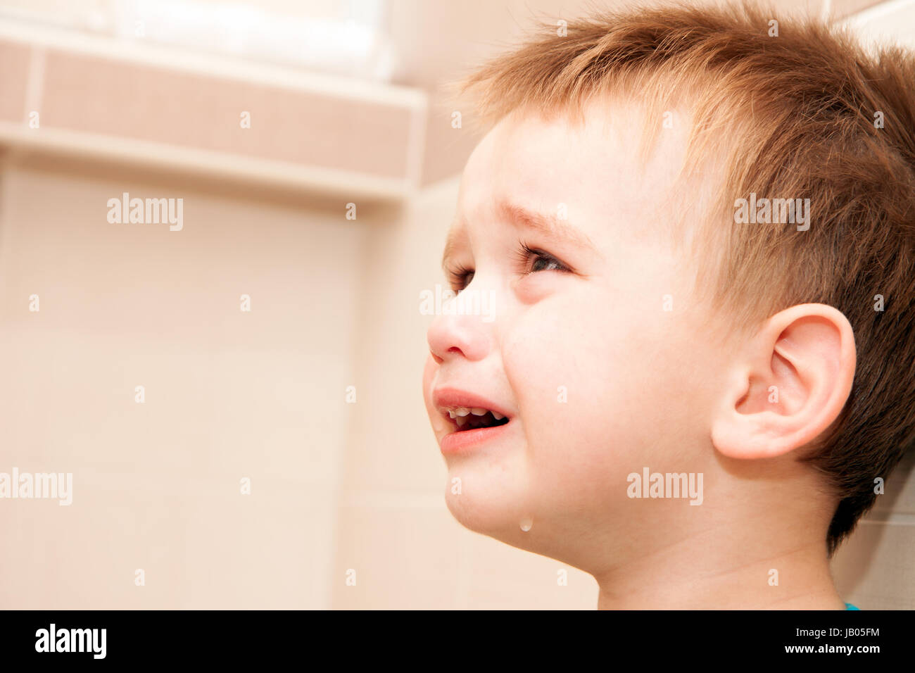 Portrait Of Crying Baby Boy In Home Stock Photo - Alamy