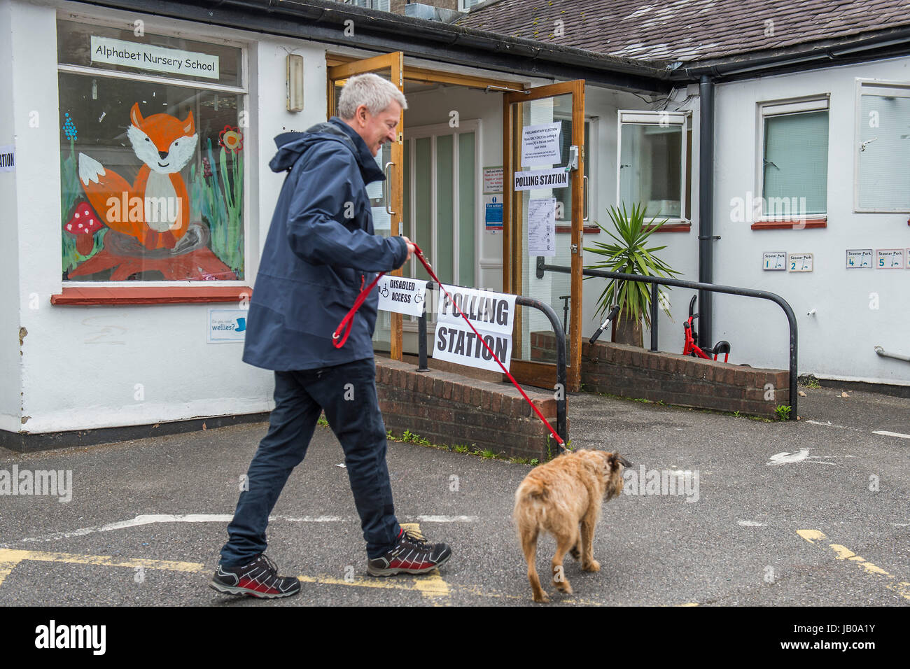 Wandsworth, London, UK. 08th June, 2017. A man brings his dog to the ...