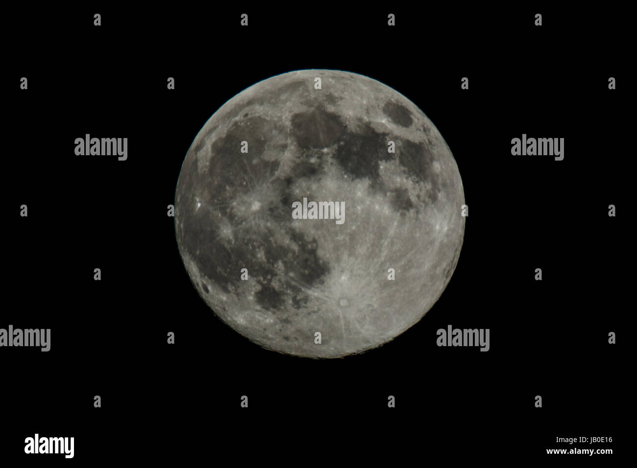 Weather: full moon makes an appearance through the clouds as the sky ...