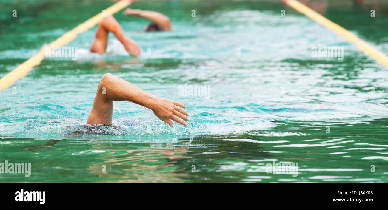 Young man swimming the front crawl in a pool Stock Photo - Alamy