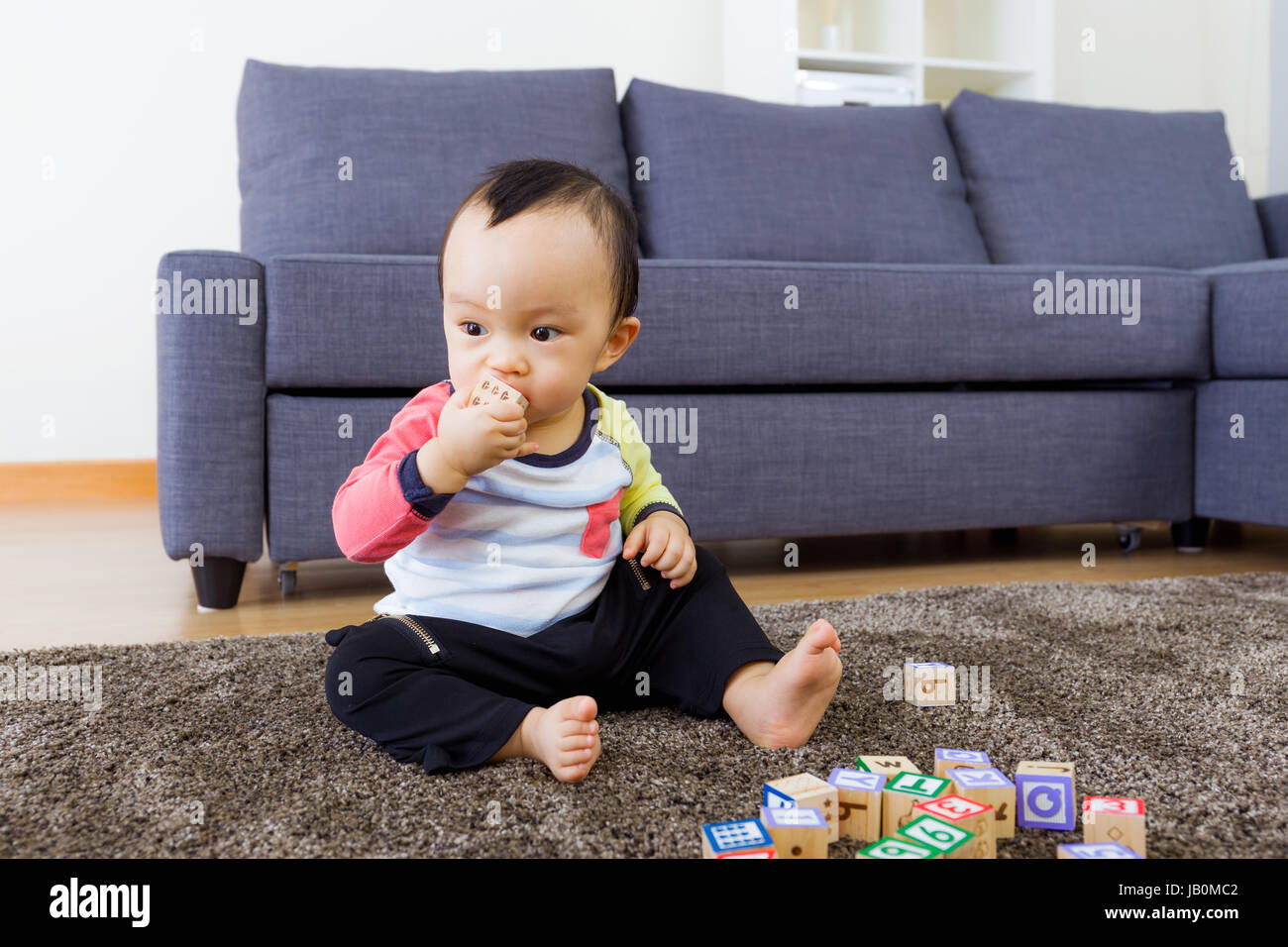 Baby boy bite toy block Stock Photo - Alamy