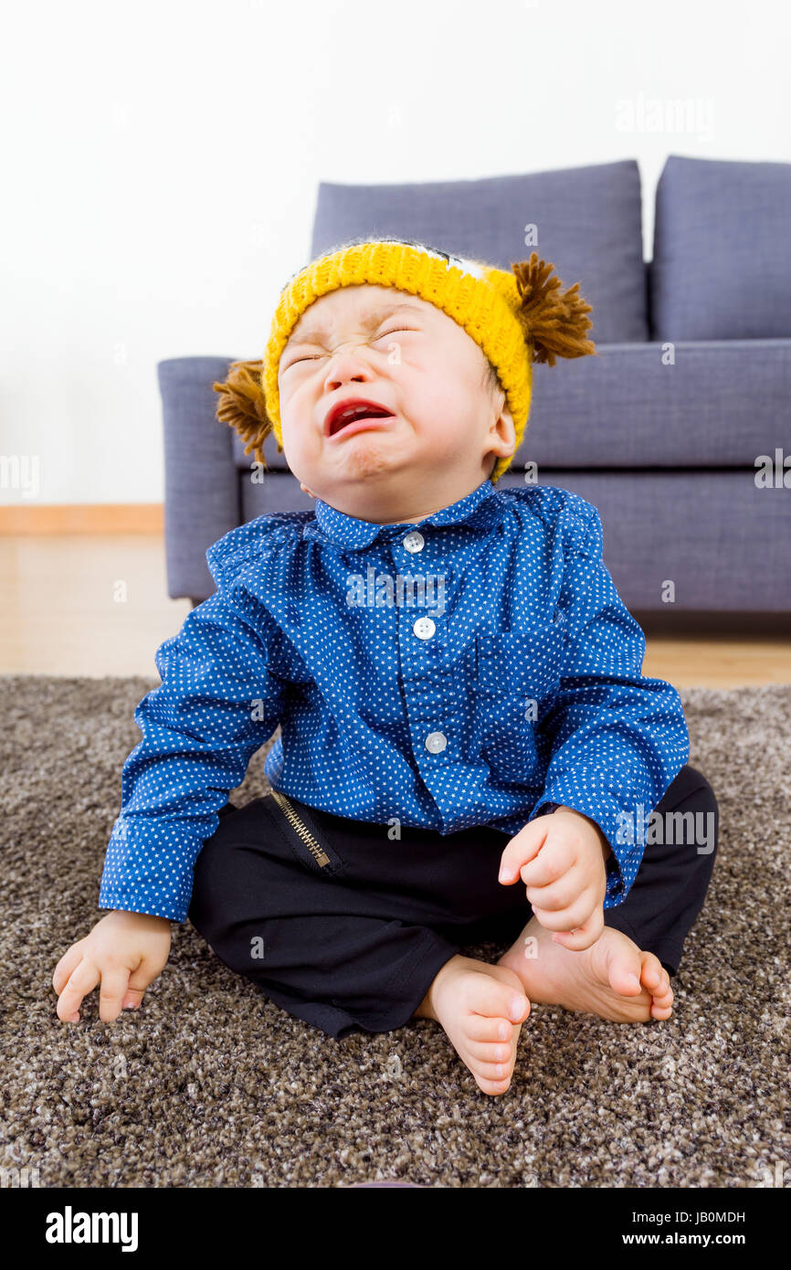 Baby crying at home Stock Photo - Alamy