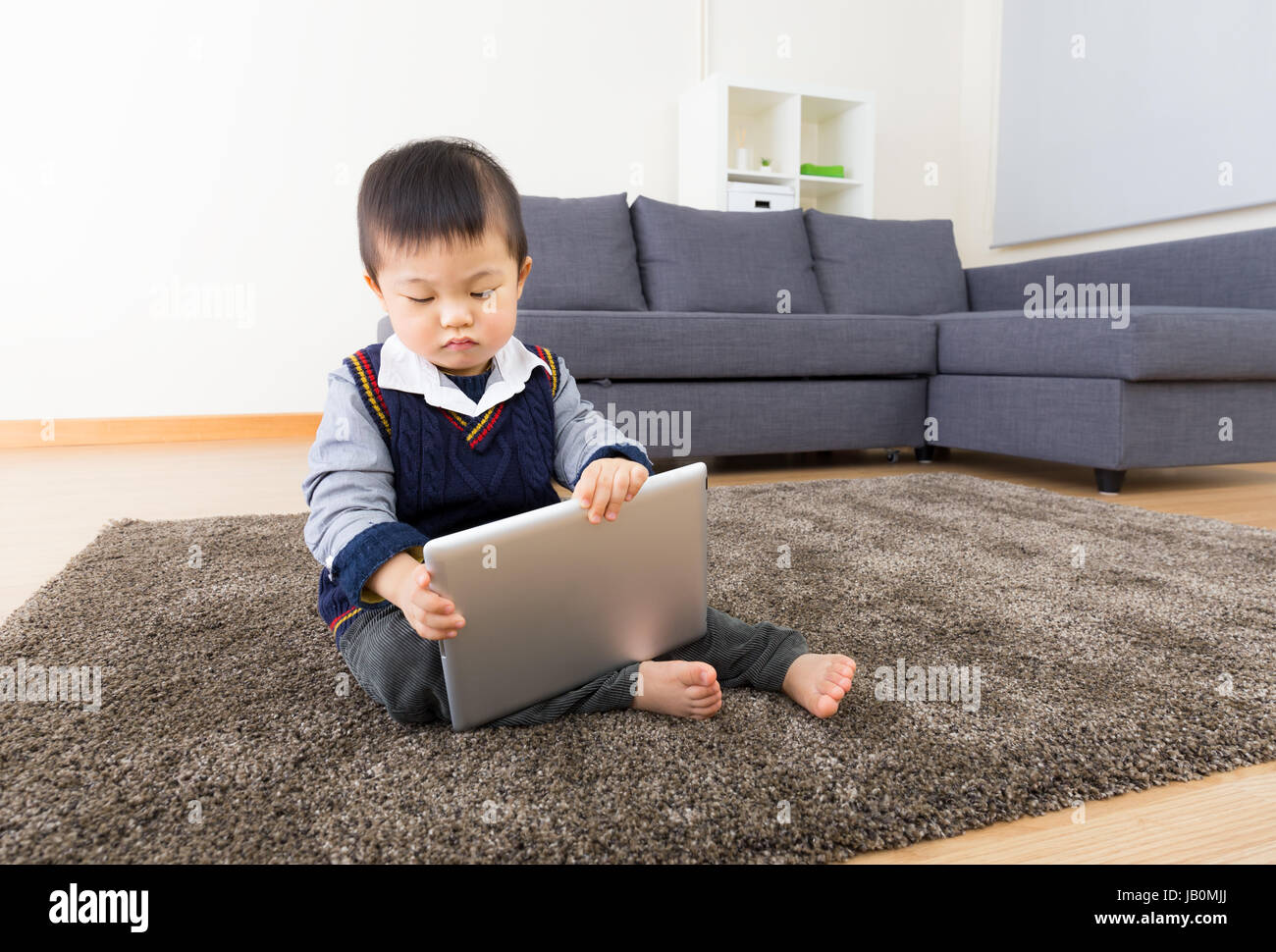 Asian boy look at tablet Stock Photo - Alamy