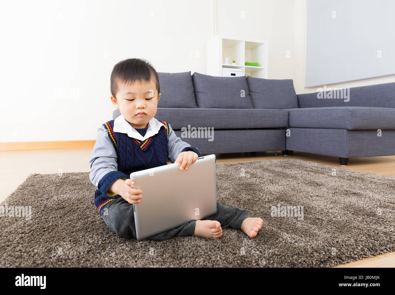 Little boy using tablet Stock Photo - Alamy